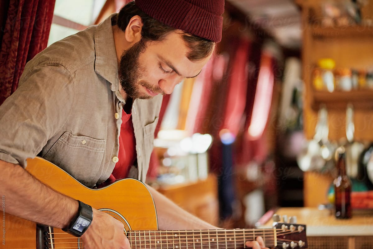 "Cool Guy Playing Guitar On House Boat" by Stocksy Contributor "Aila ...