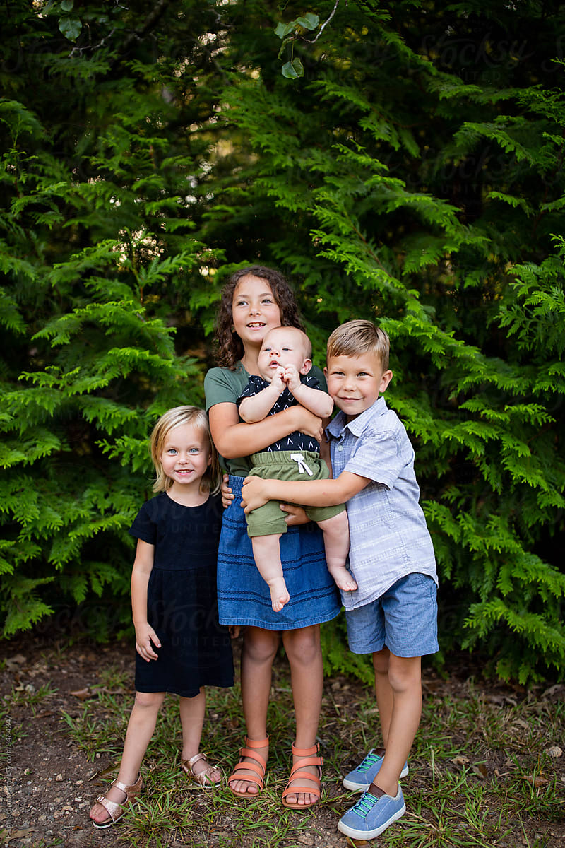 "Four Young Siblings" by Stocksy Contributor "Paige Stumbo" - Stocksy