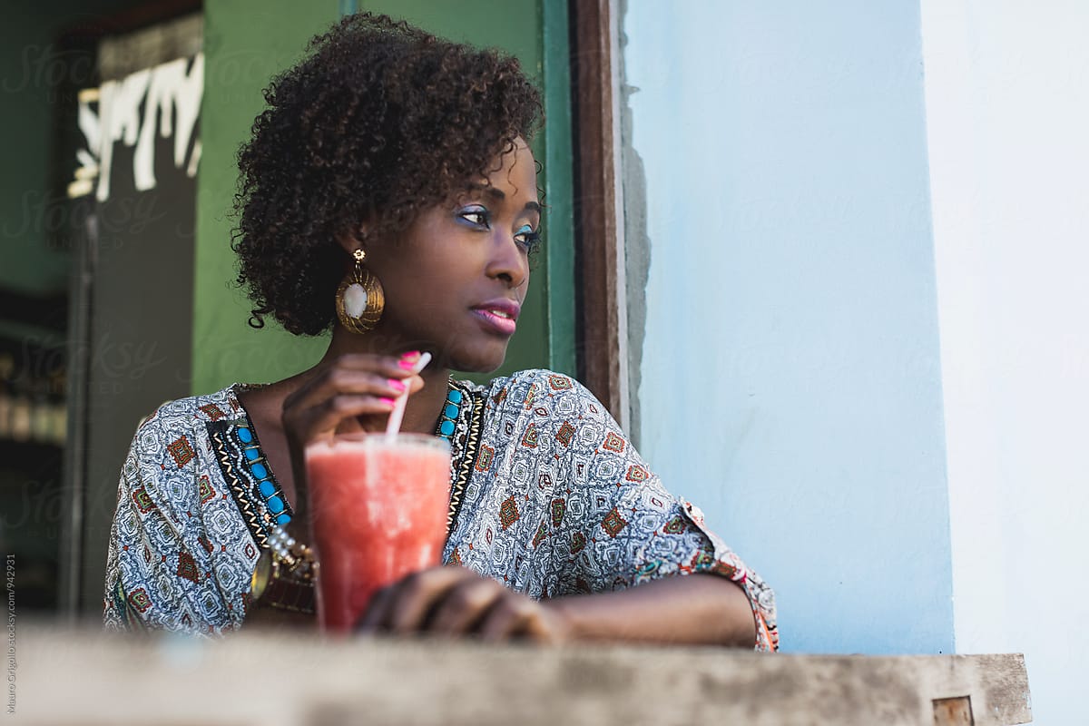 "Black Woman Drinking Fresh Juice In A Bar" by Stocksy Contributor ...