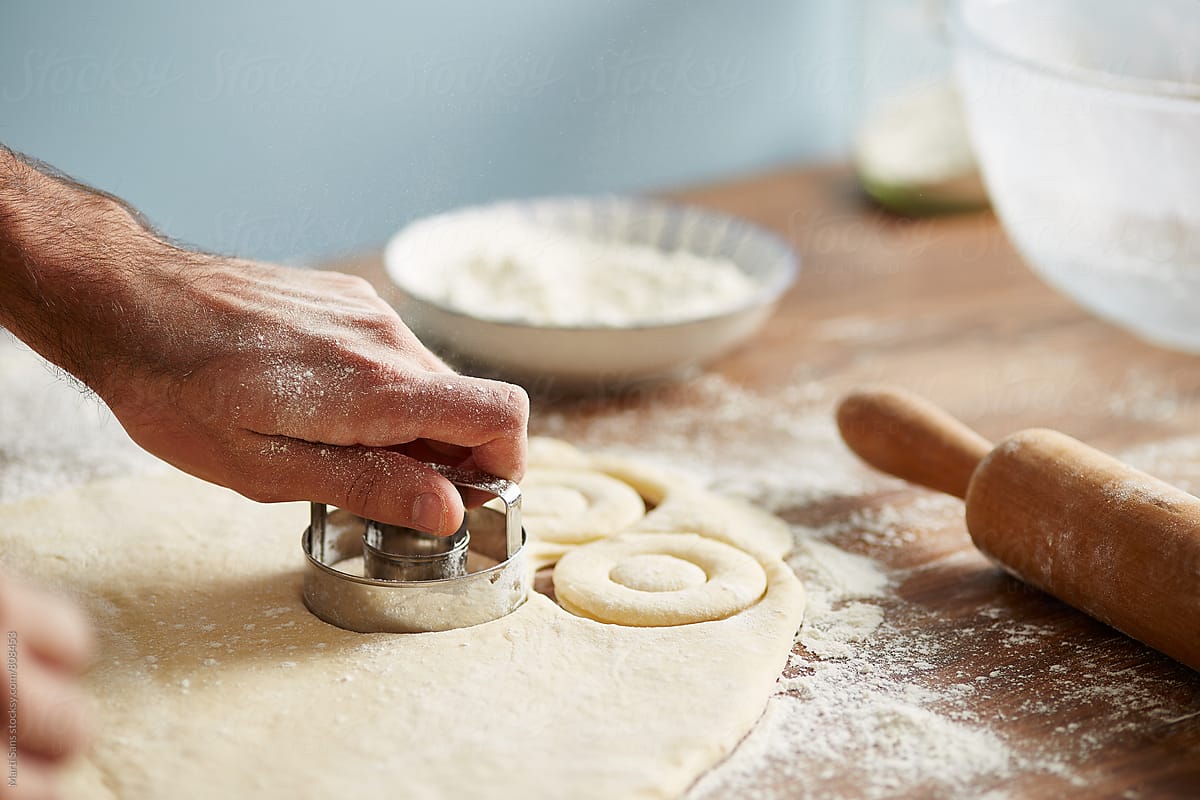 "Cutting Homemade Doughnuts" by Stocksy Contributor "Martí Sans" - Stocksy