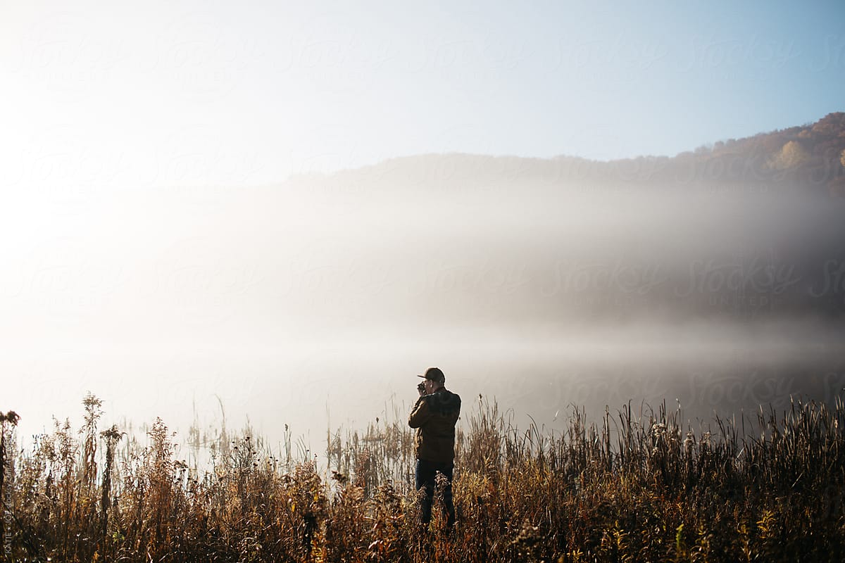 "Man Standing In A Foggy Meadow At Sunrise" by Stocksy Contributor ...