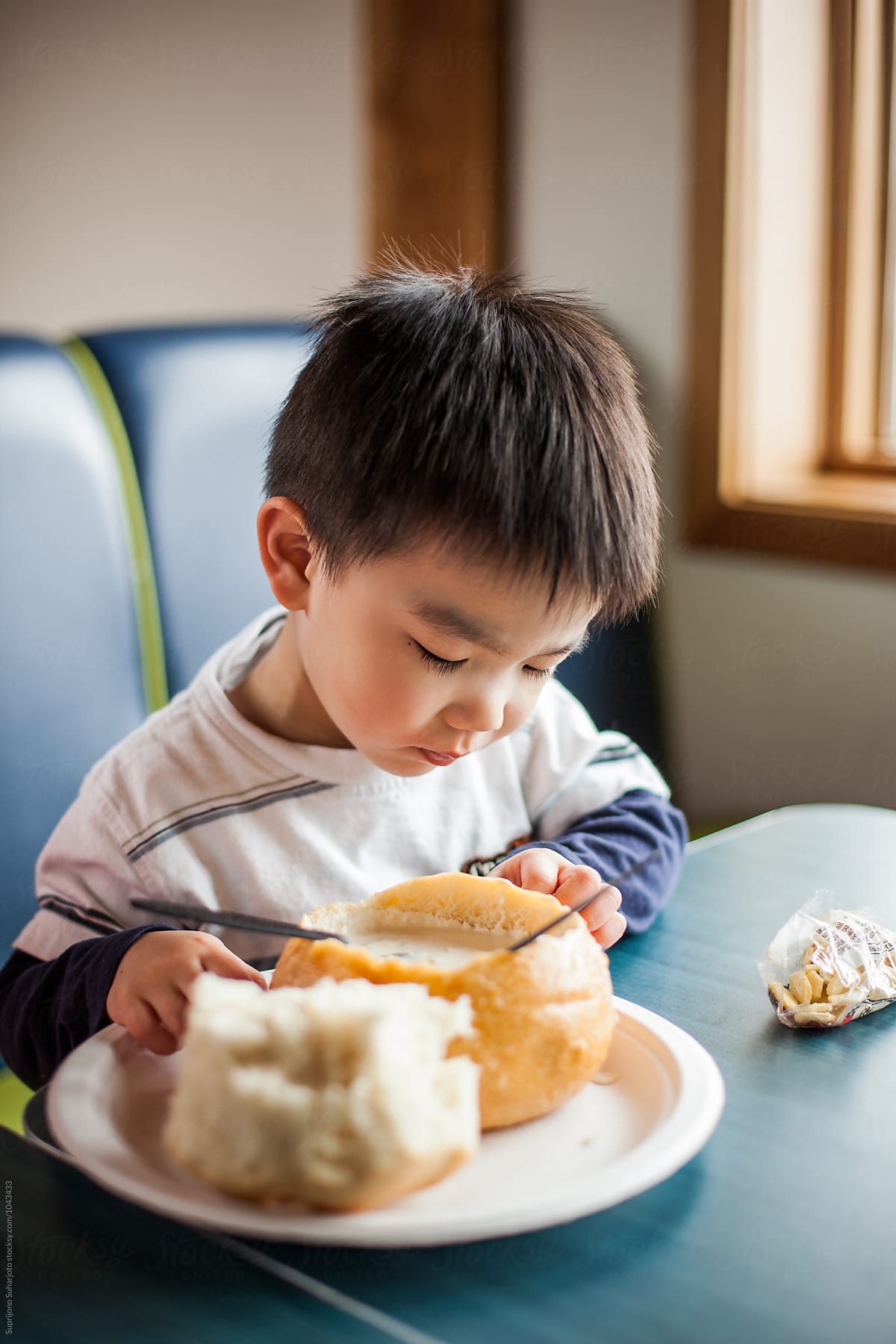 "Asian Boy Eating Clam Chowder In A Bread Bowl" by Stocksy Contributor ...