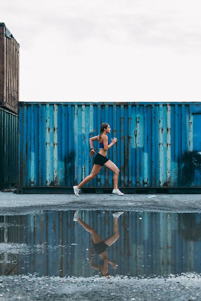 "Woman Running Outdoors" by Stocksy Contributor "Studio Firma" - Stocksy