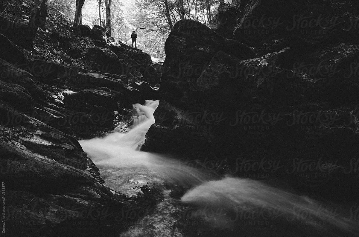 "Man On River Edge With Cliffs And Rocks With Rapids" by Stocksy ...