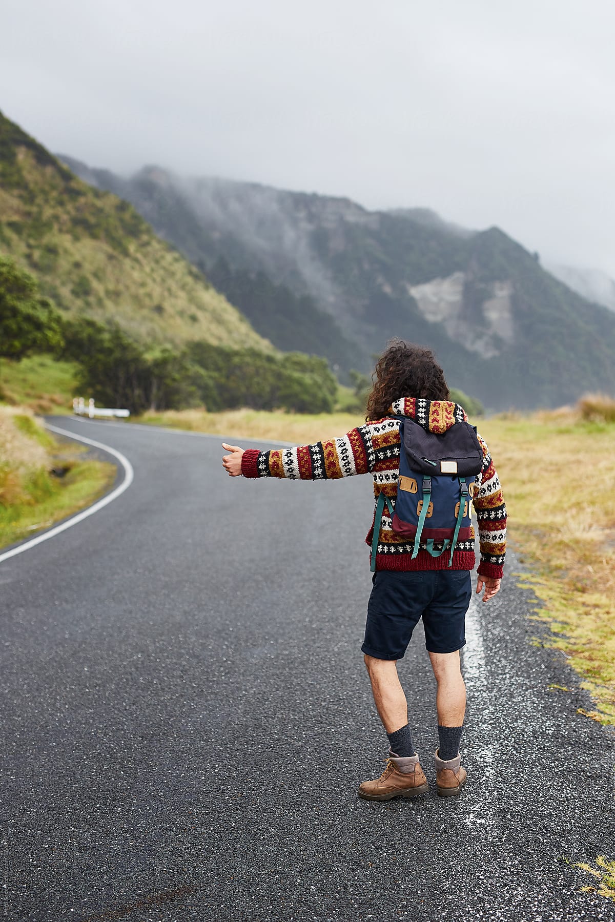 "Backpacker Thumbing For A Ride" by Stocksy Contributor "Martí Sans ...