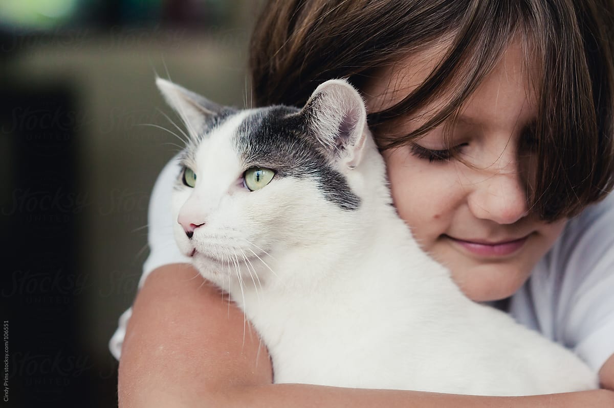 "Boy Hugging His Cat" by Stocksy Contributor "Cindy Prins" - Stocksy