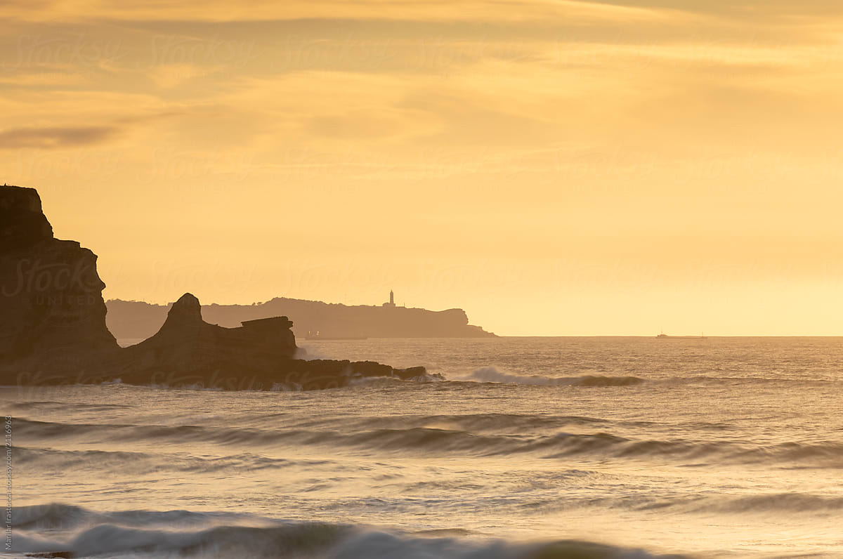 "Coastline In A Orange Haze At Sunset" by Stocksy Contributor "Marilar ...