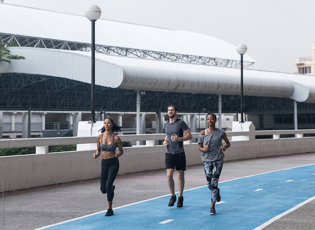 "Three Friends Exercising Together On Running Track" by Stocksy ...