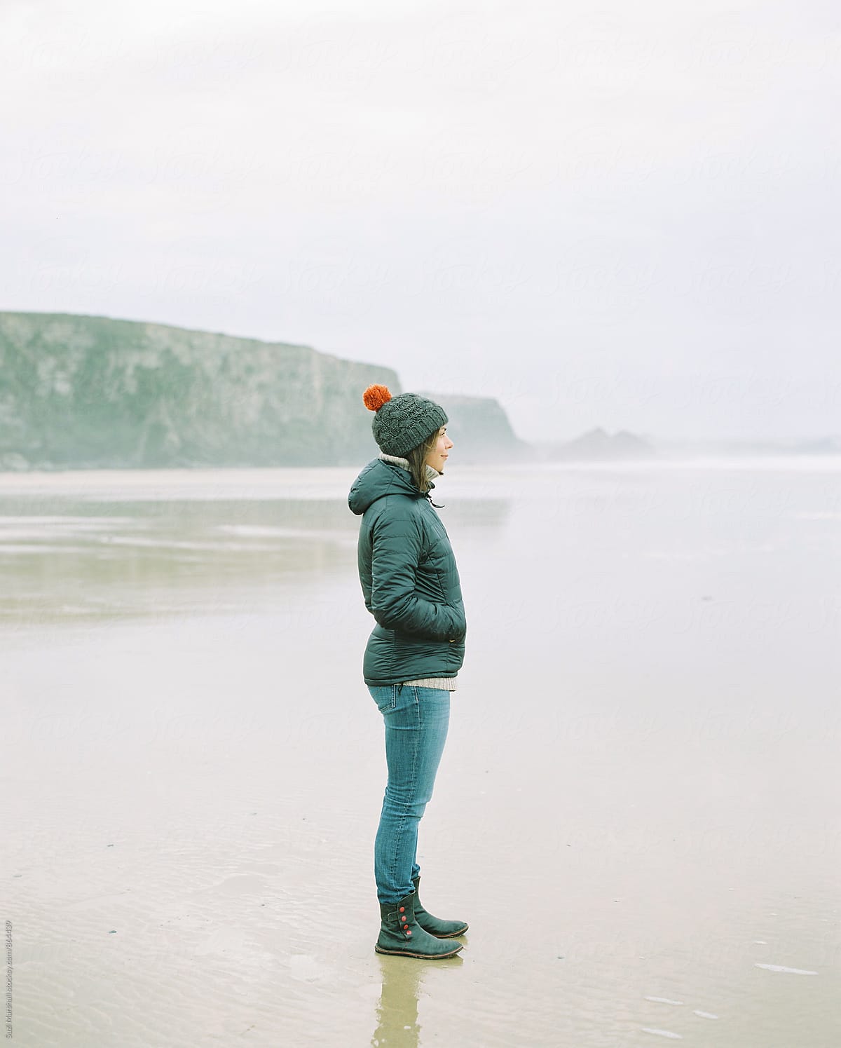 "Woman Standing On A Beach On A Foggy Winter Day Looking Out To Sea" by ...