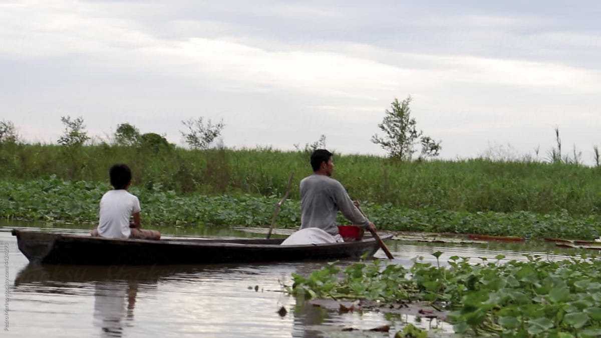 "Father And Son Sailing The Amazon River" by Stocksy Contributor "Pedro ...