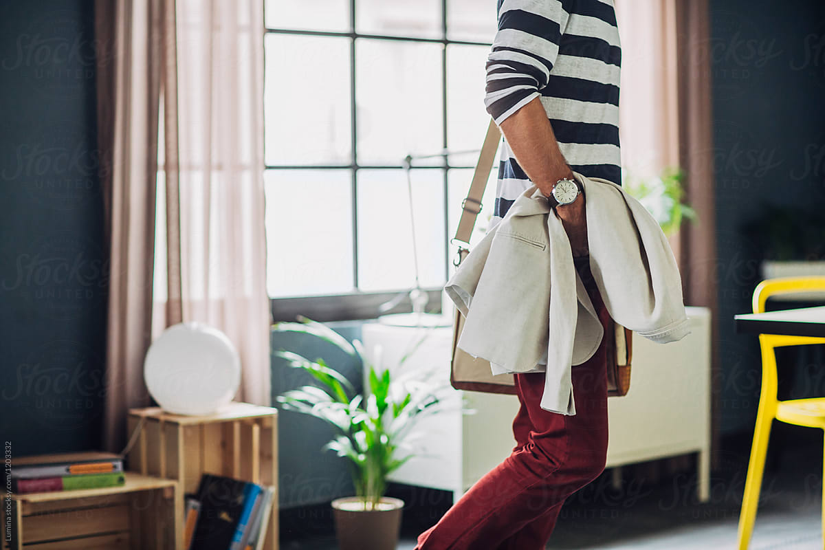 "A Man Carrying A Bag And A Jacket" by Stocksy Contributor "Lumina ...
