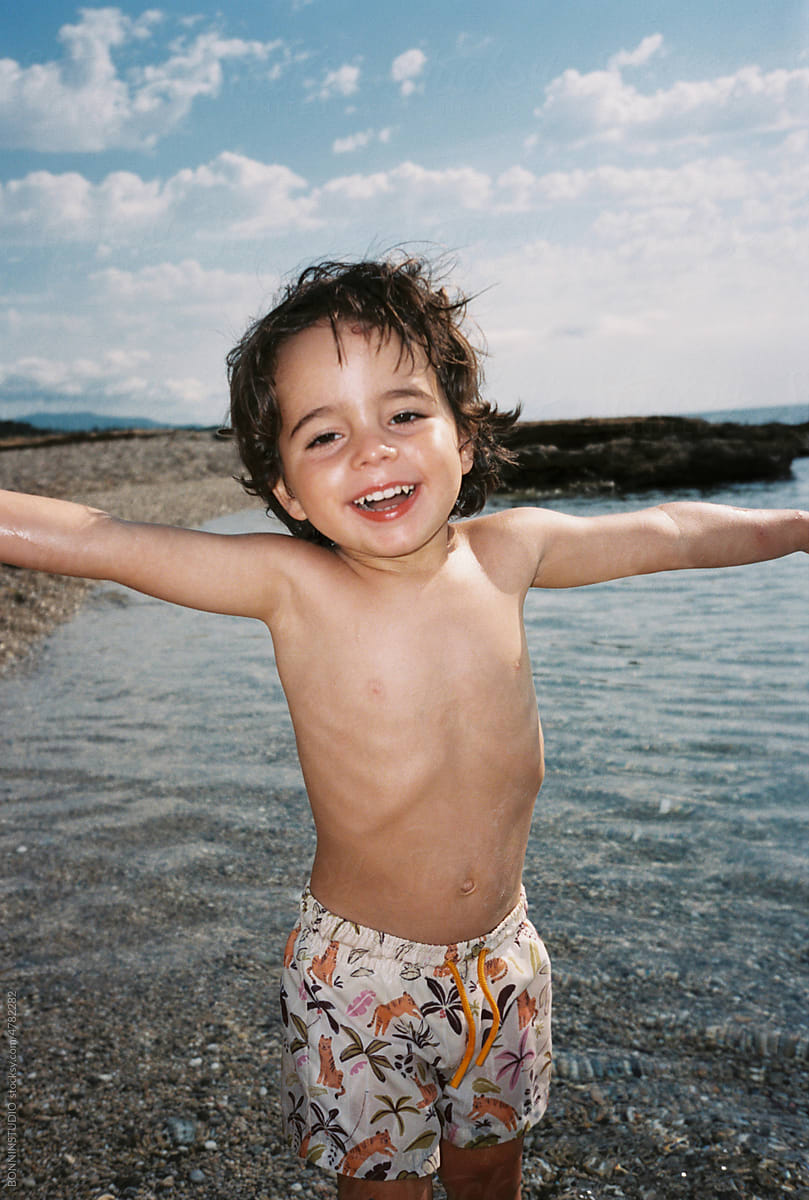 "Young Child On The Beach" by Stocksy Contributor "BONNINSTUDIO " - Stocksy