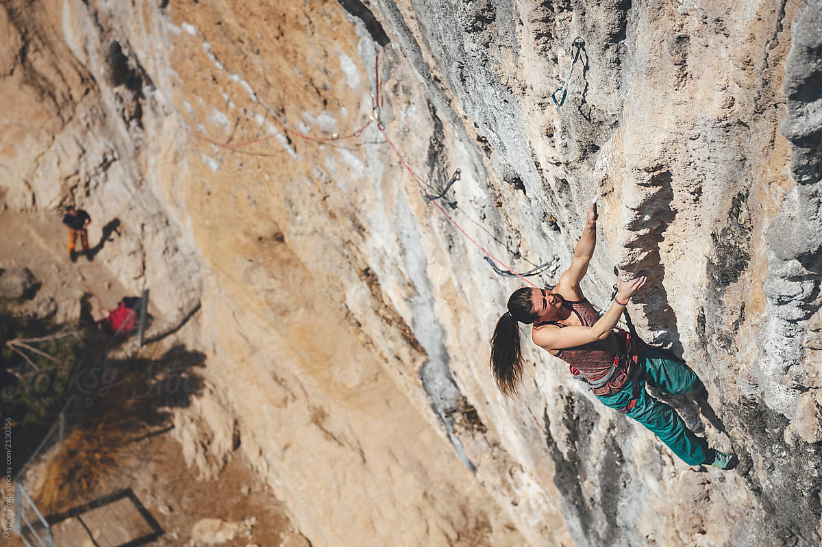 "Sportswoman Rock Climbing" by Stocksy Contributor "Manu Prats" - Stocksy