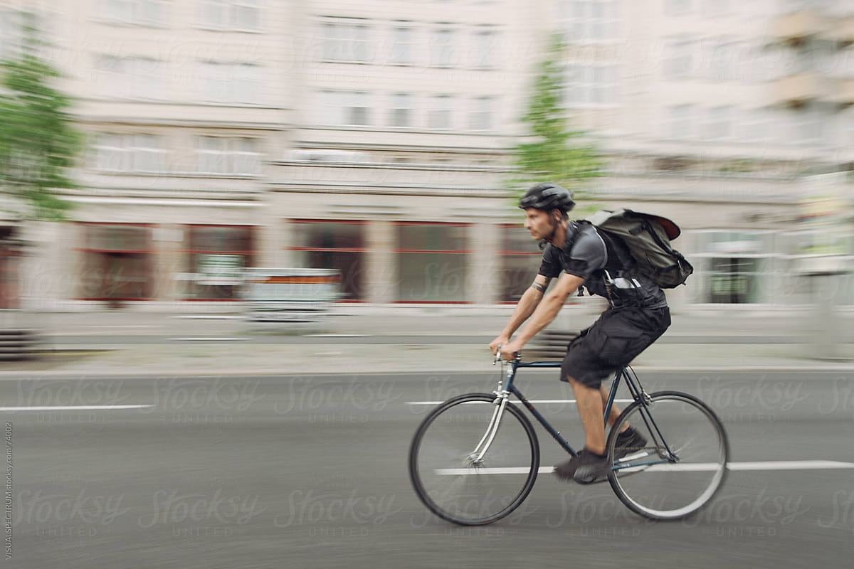 "Bicycle Messenger" by Stocksy Contributor "VISUALSPECTRUM" - Stocksy