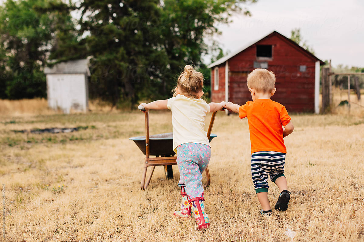 "Blonde Toddler Siblings Pushing A Wheelbarrow Together." by Stocksy ...