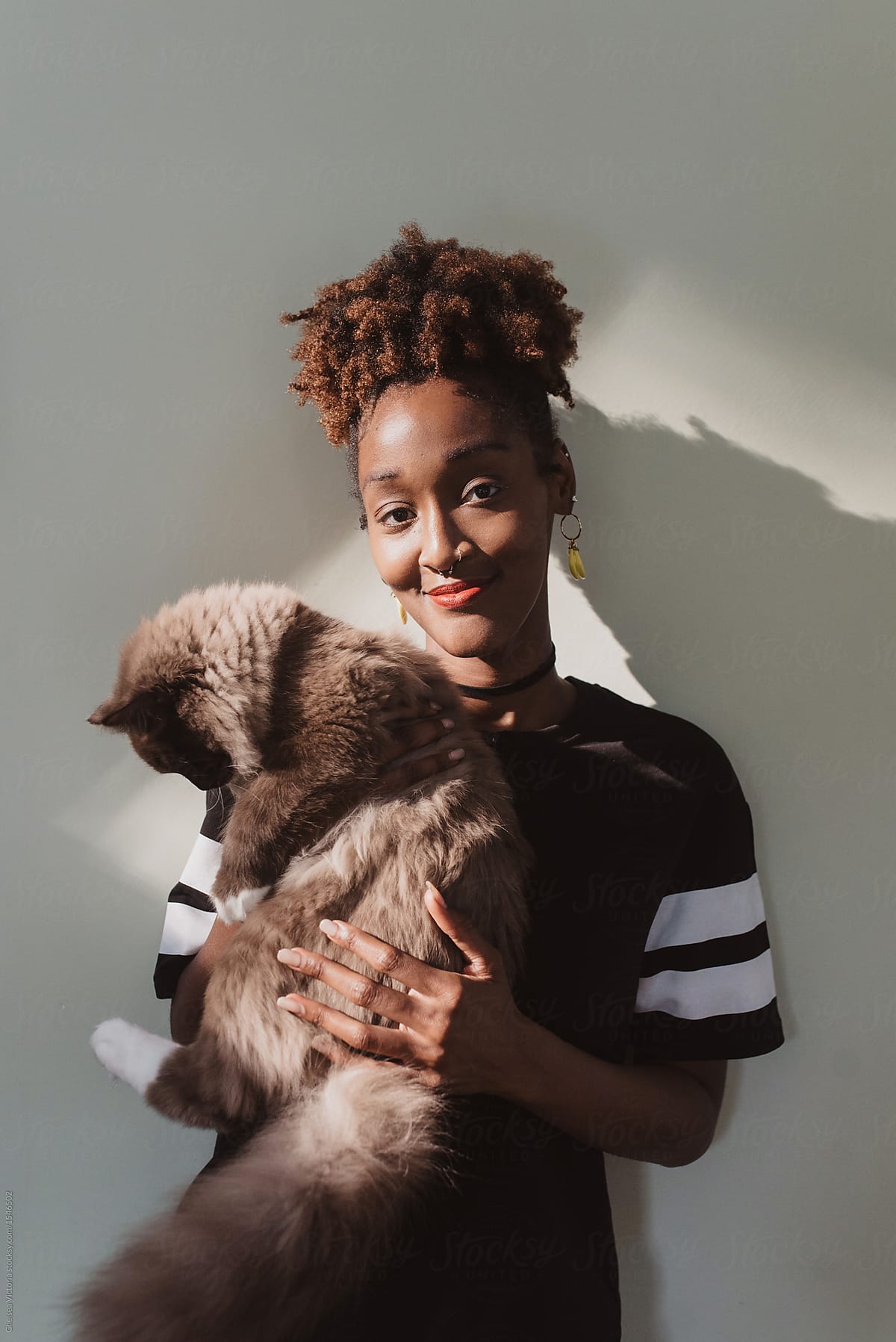 "An African American Woman At Home Playing With Her Cat" by Stocksy ...
