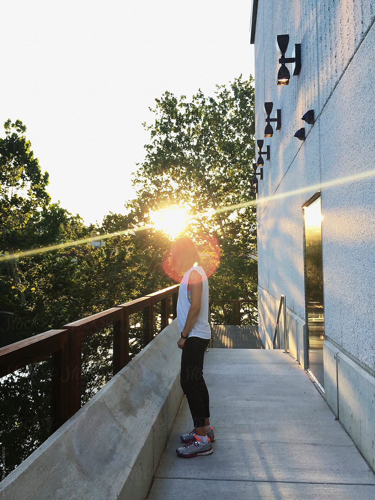 "Fit Woman Standing In The Sun" by Stocksy Contributor "Holly Clark ...