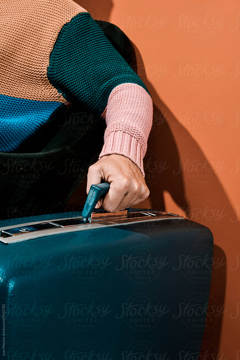 "Man Sitting And Grabbing The Handle Of A Retro Suitcase" by Stocksy ...