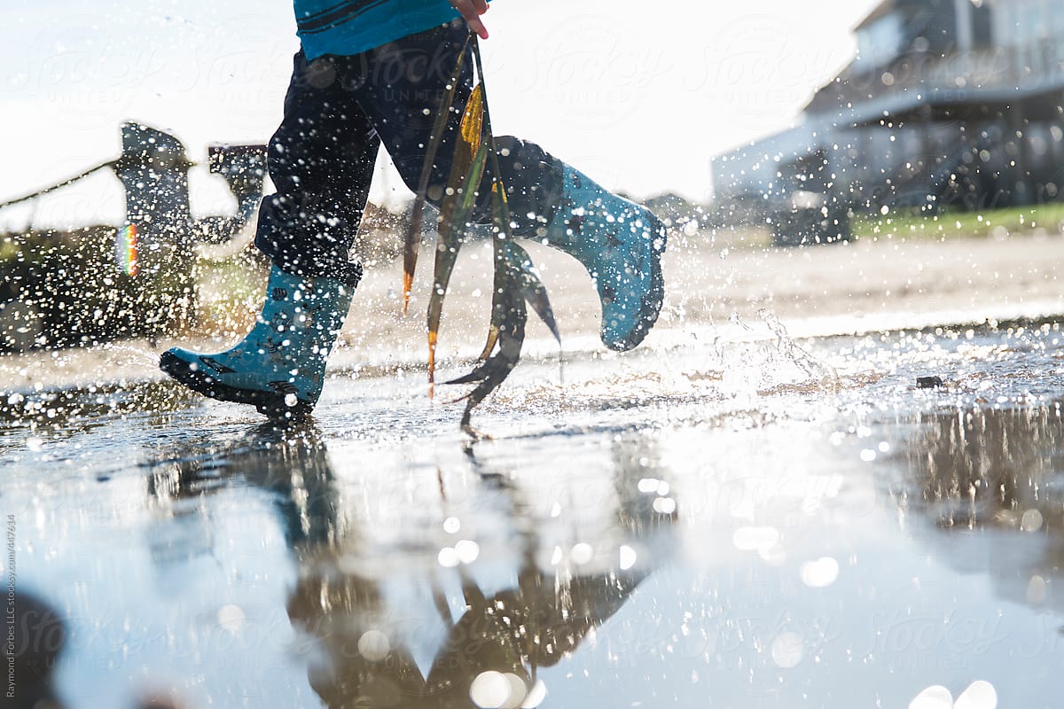 "Child Splashing In Puddle" by Stocksy Contributor "Raymond Forbes LLC ...