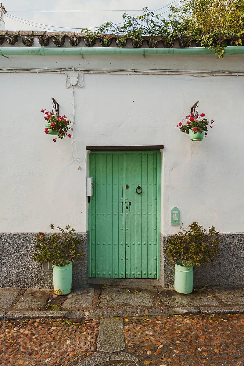 "A Quaint, White-walled Building Features A Pale Green, Wooden Door" by ...