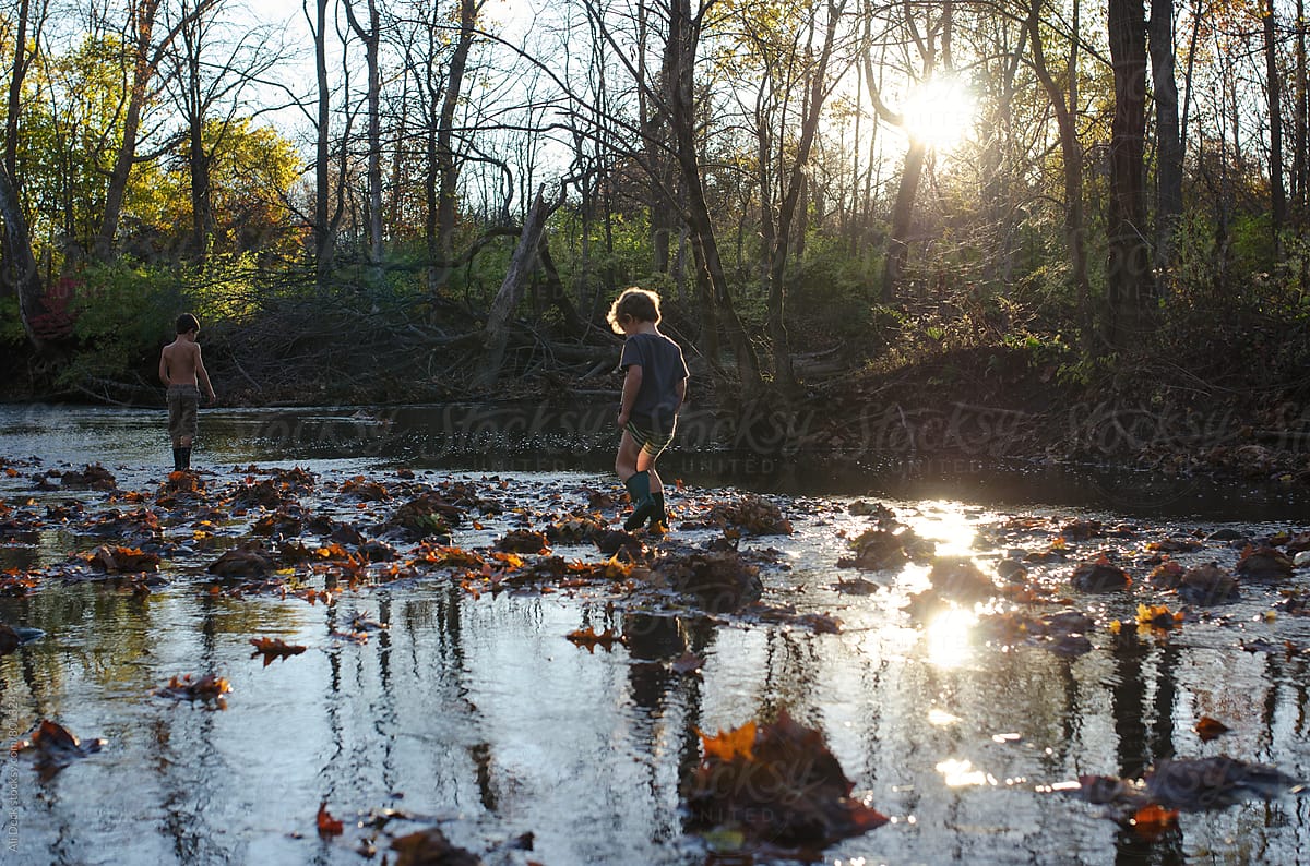 "Boys Walk In A Creek" by Stocksy Contributor "Ali Deck" - Stocksy