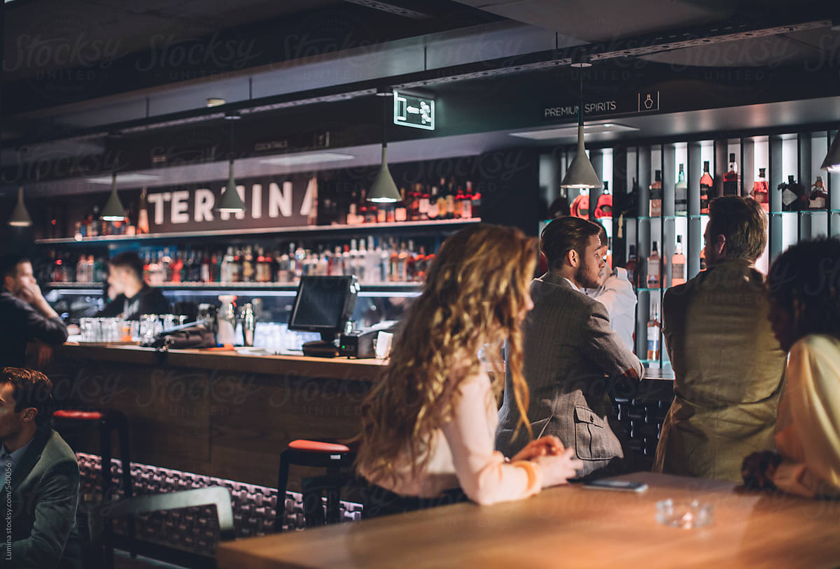 "People At A Bar" by Stocksy Contributor "Lumina" - Stocksy
