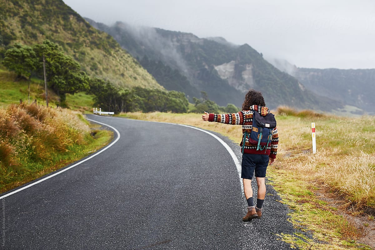 "Back View Of Man Thumbing For A Ride" by Stocksy Contributor "Martí ...