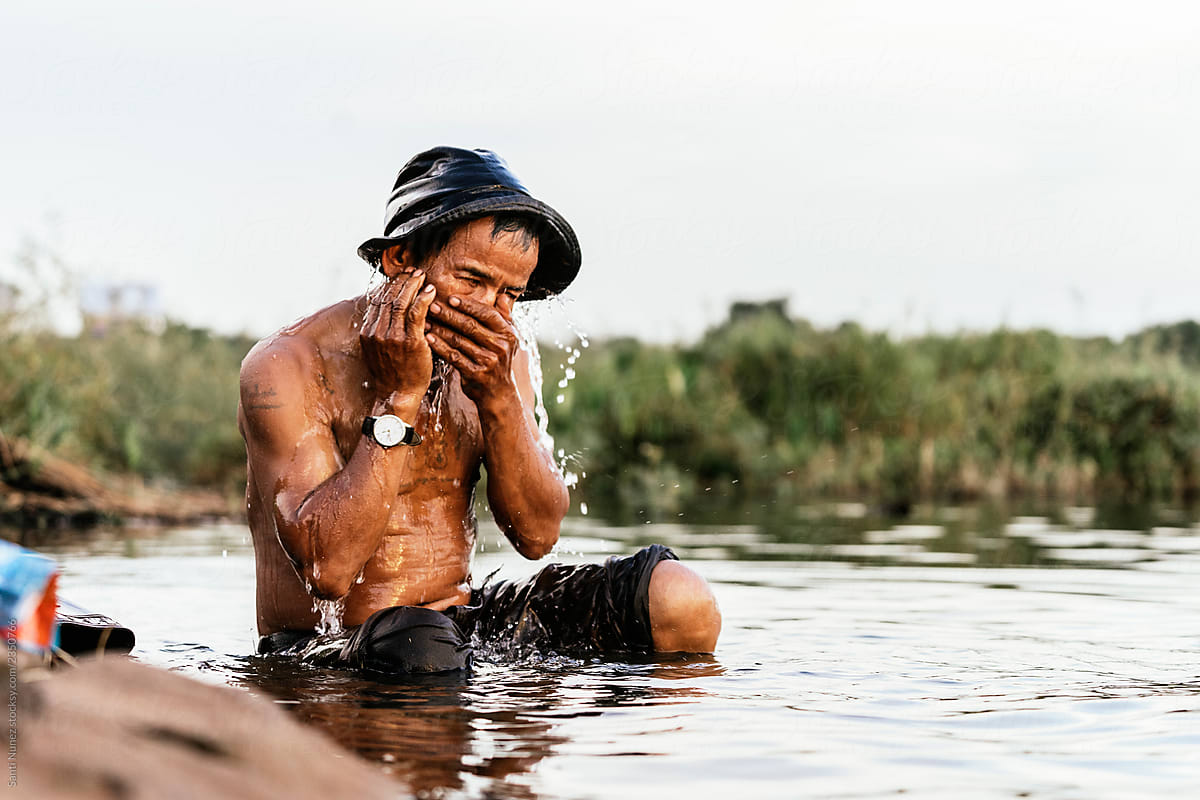 "Senior Man Bathing In Lake" by Stocksy Contributor "Santi Nuñez" - Stocksy