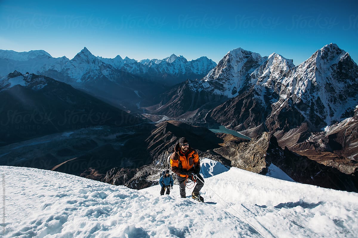 "Men Climbing Up The Mountain" by Stocksy Contributor "Marko" - Stocksy