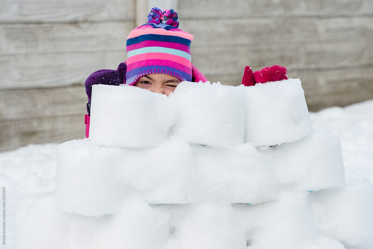"Girl Hiding Behind Snow Fort" by Stocksy Contributor "Ronnie Comeau ...