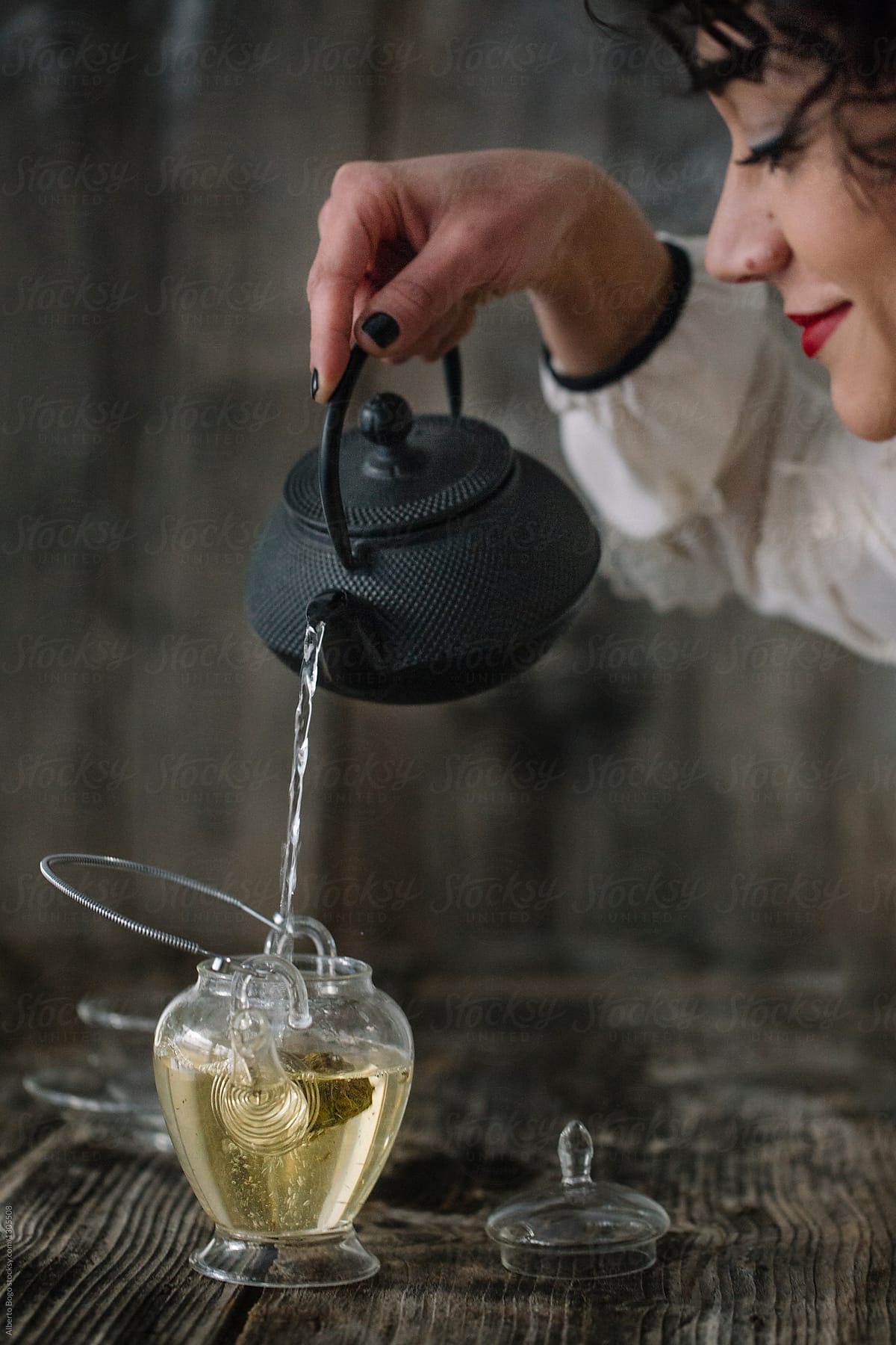 "Person Pouring A Tea" by Stocksy Contributor "Studio Serra" - Stocksy