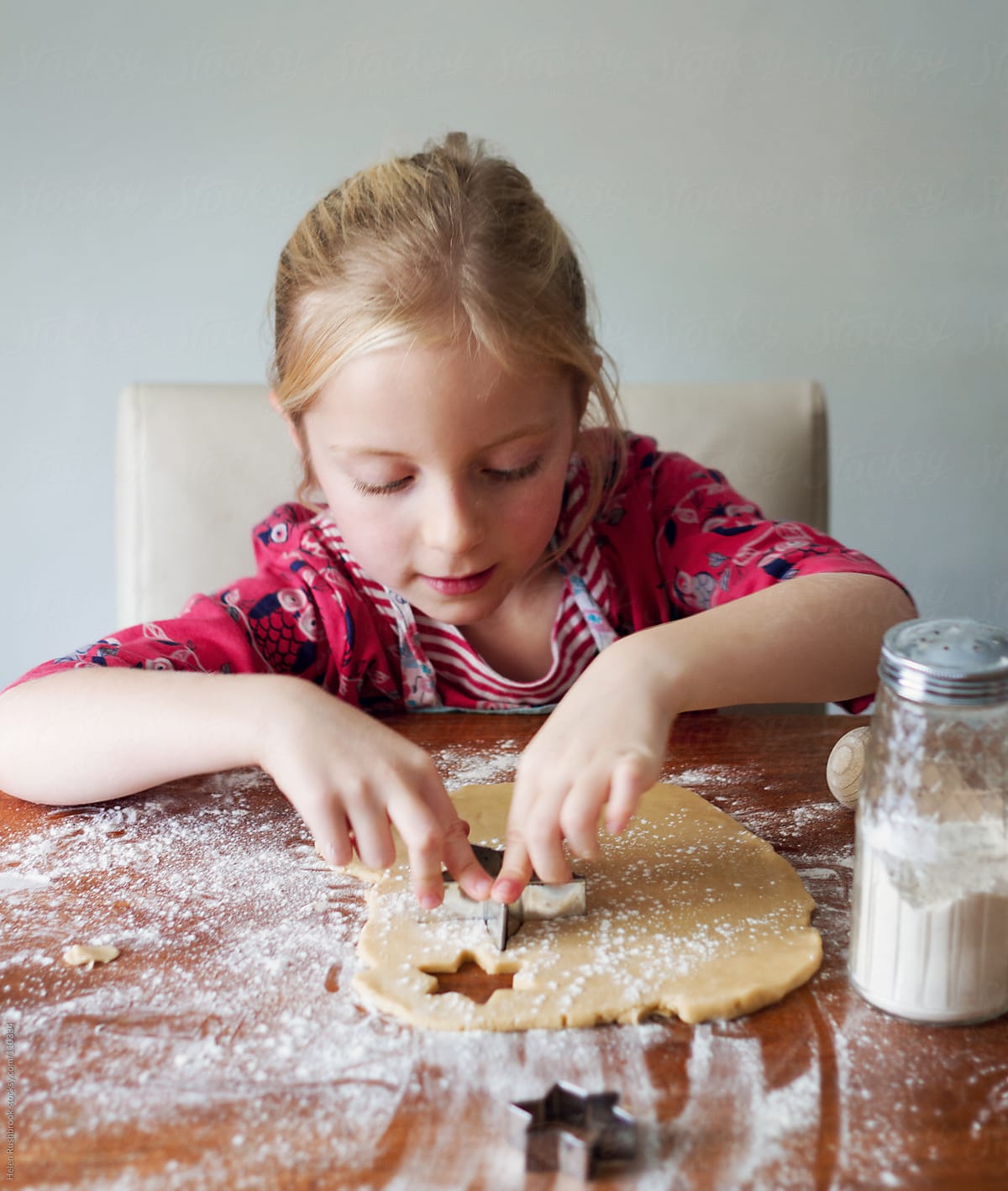 "A Little Girl Baking Biscuits" by Stocksy Contributor "Helen Rushbrook ...