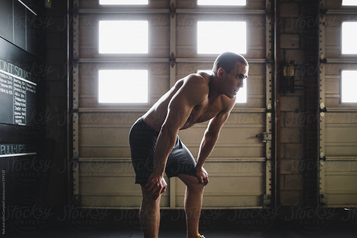 "Portrait Of Young, Fit And Sweaty Man Recovering In Gritty Gym" by ...