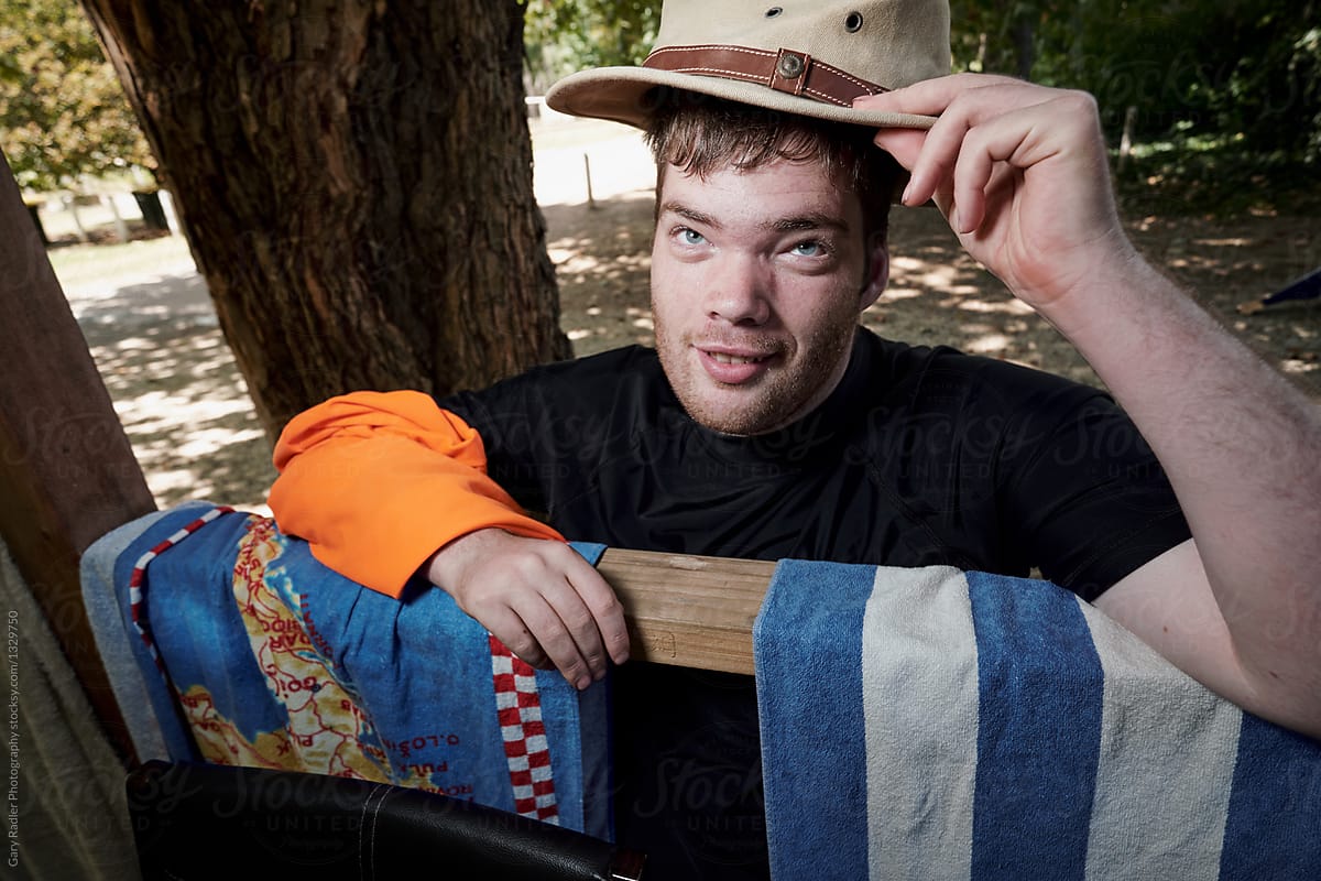 "Man Doffing His Hat While Leaning On Some Towels Drying Outside" by ...