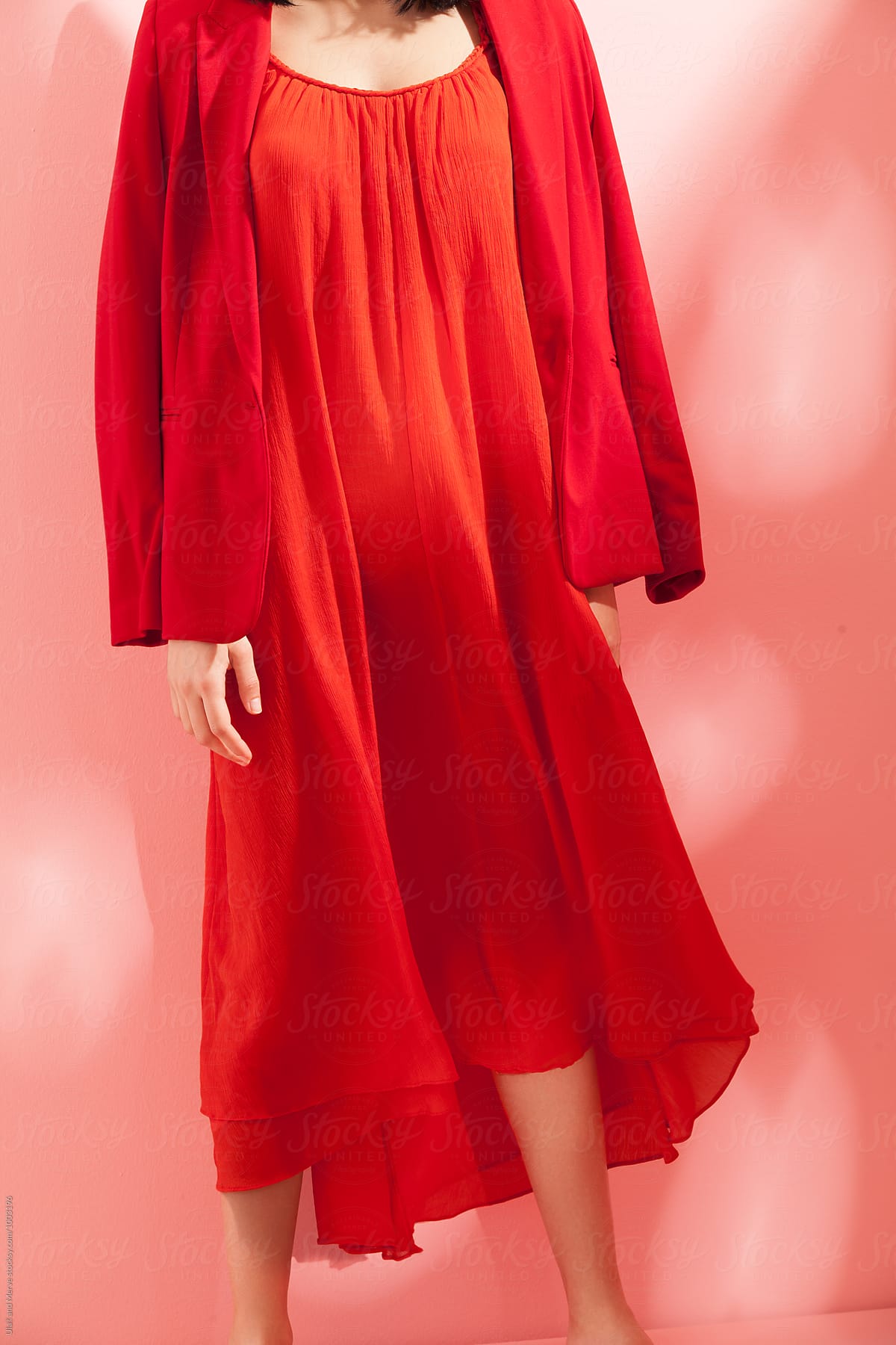 "Woman With Red Dress And Jacket Standing" by Stocksy Contributor "Ulas ...