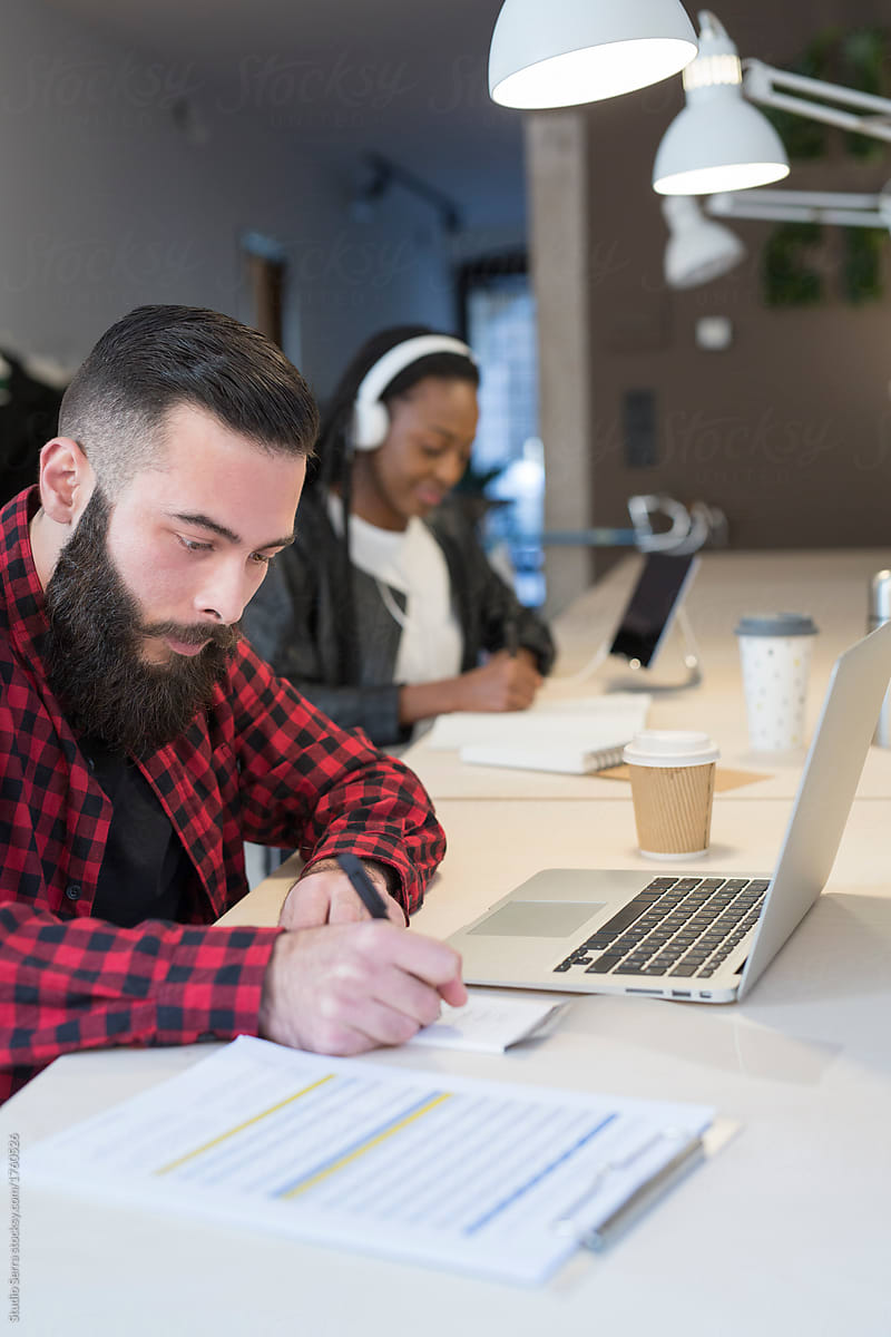 Young colleagues concentrated on work - Stock Image - Everypixel