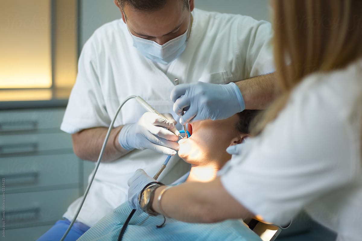 "Close Up The Dentist Fixes The Patient's Tooth" by Stocksy Contributor ...