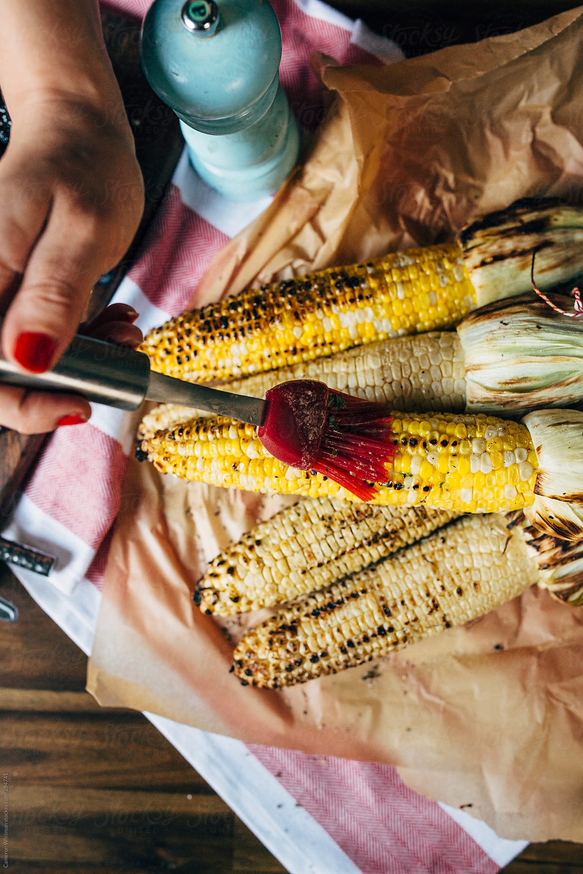 "Basting Corn On The Corb With Herb Butter" by Stocksy Contributor "CWP ...