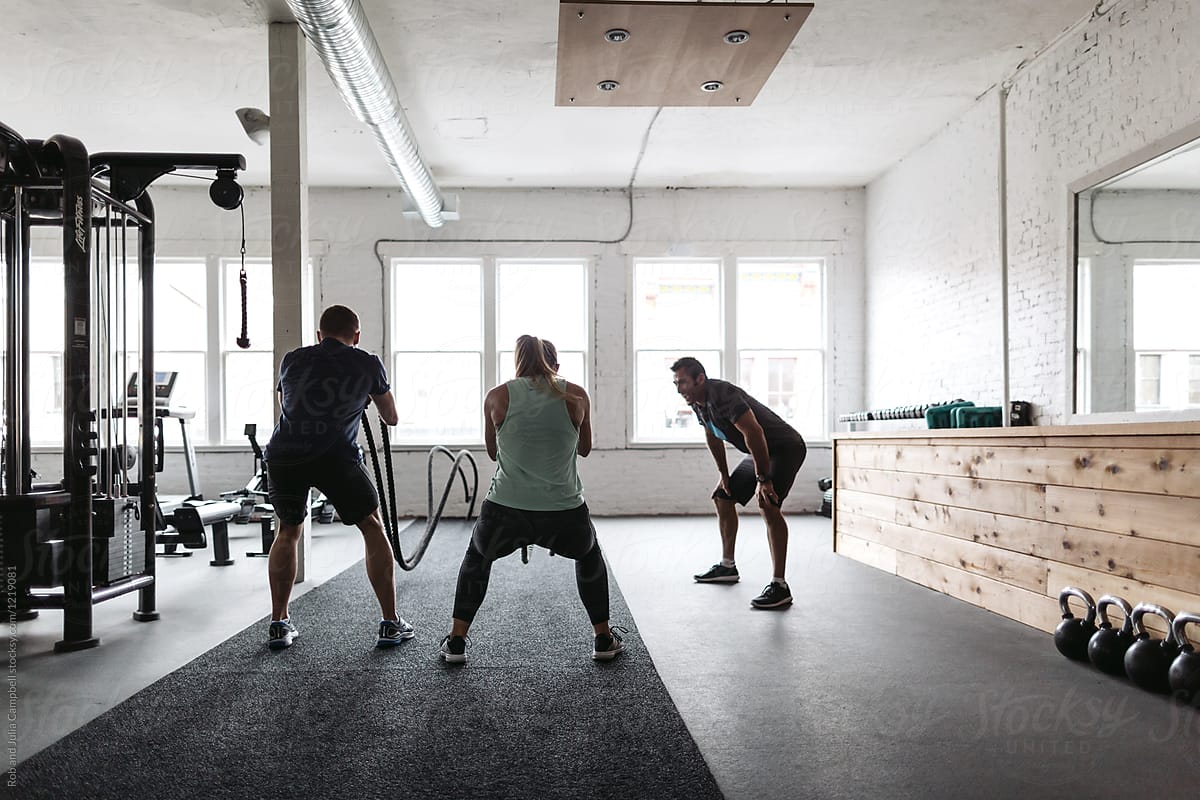 "Personal Trainer Encouraging People On Battle Ropes" by Stocksy ...