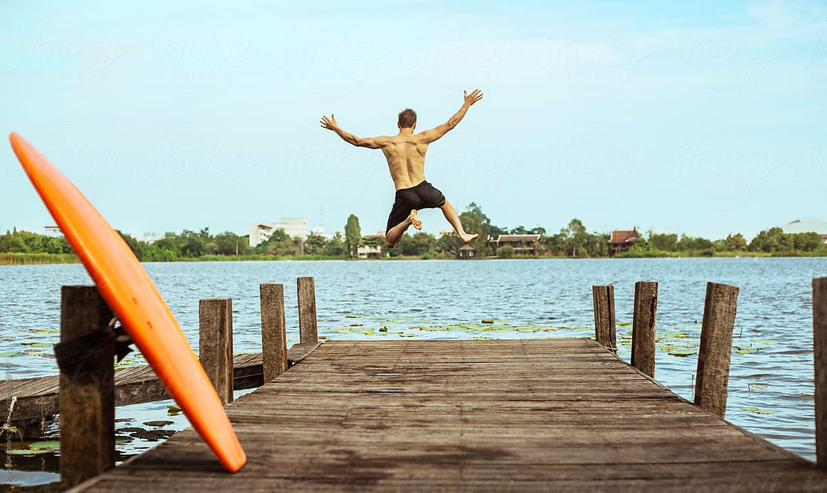 "Young Man Jumping Into The Lake From A Wooden Pier" by Stocksy ...