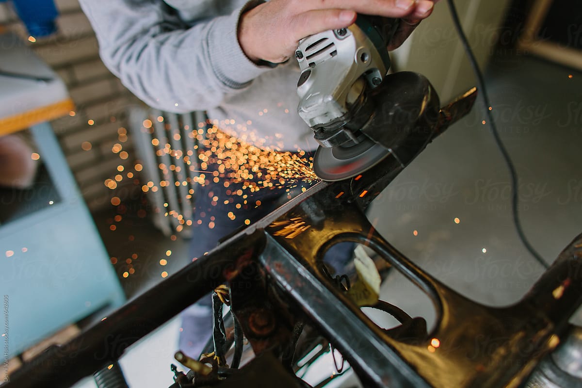 "A Man Grinding And Creating Sparks In His Garage." by Stocksy ...