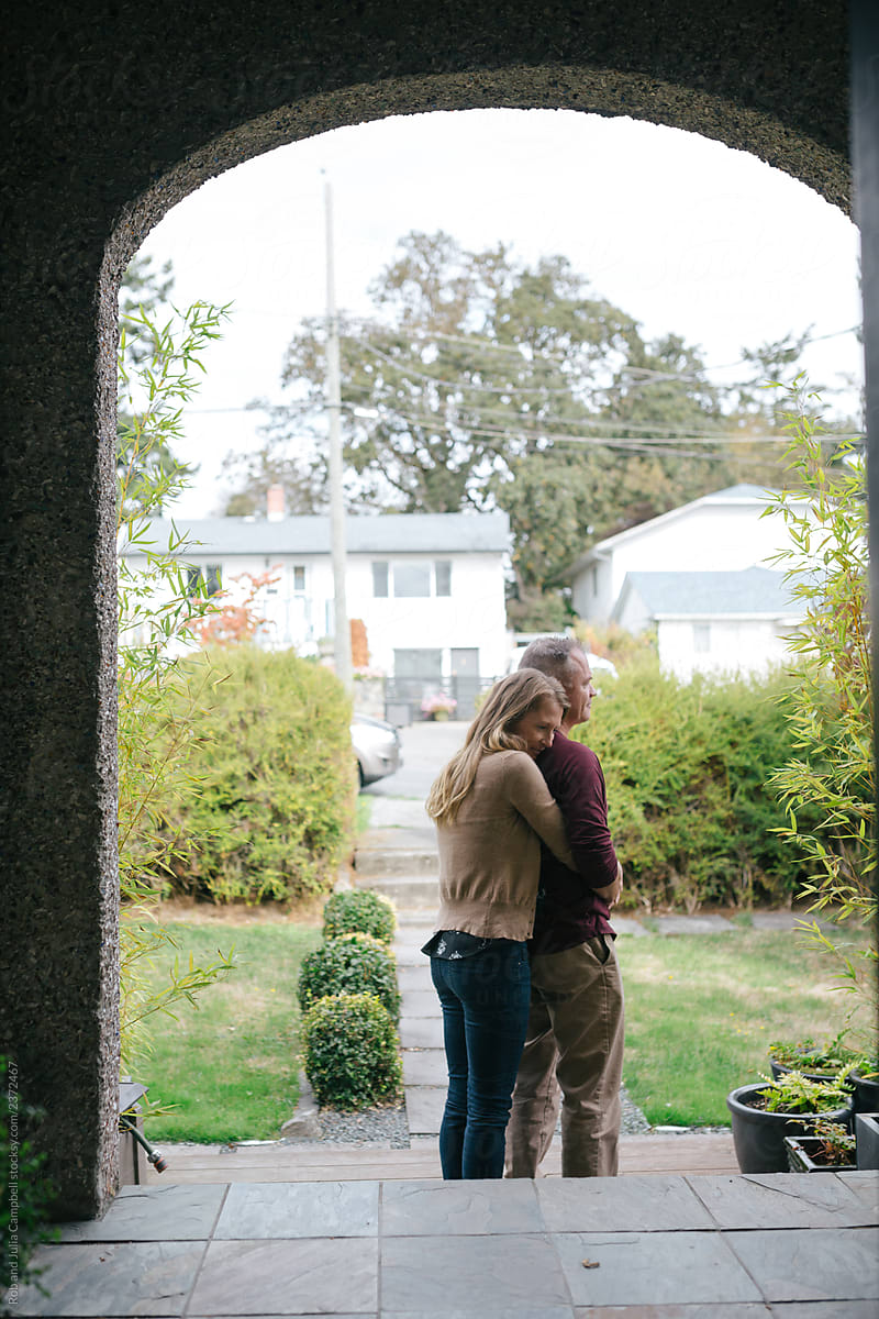 "Serious Couple Hugging Together At Home." by Stocksy Contributor "Rob ...
