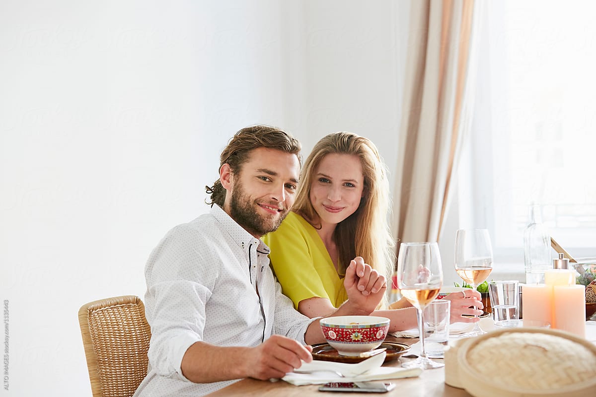"Portrait Of Happy Couple Sitting At Dining Table" by Stocksy ...