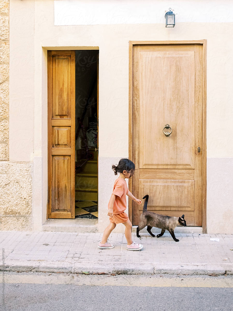 "Child And Cat Walking Side By Side On Sidewalk" by Stocksy Contributor ...
