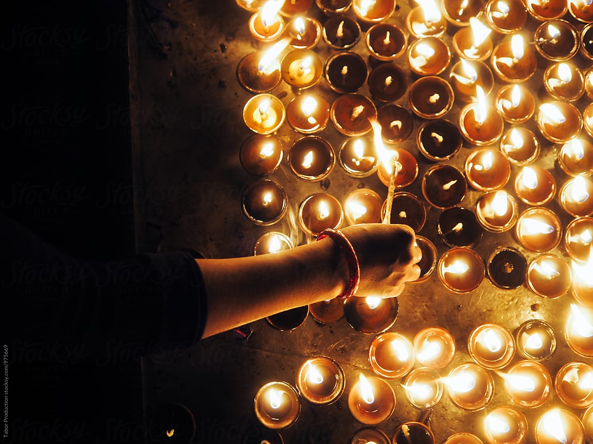 "Female Hand Firing The Candles" by Stocksy Contributor "Artem Zhushman ...
