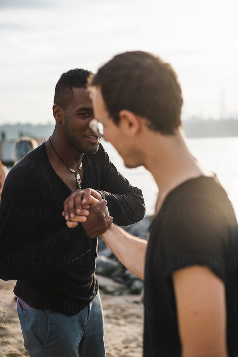 "Two Male Friends Greeting Outdoors" by Stocksy Contributor "Koganami ...