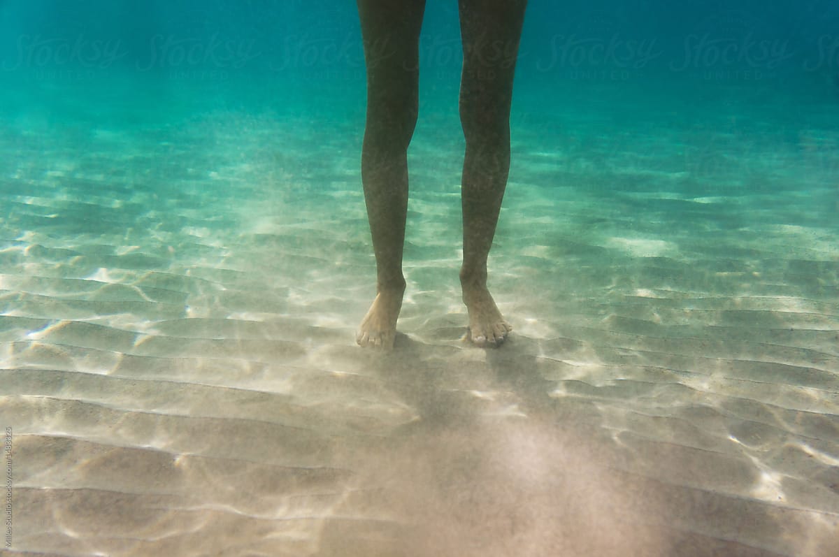 "Legs Of Person In Ocean" by Stocksy Contributor "Milles Team" - Stocksy