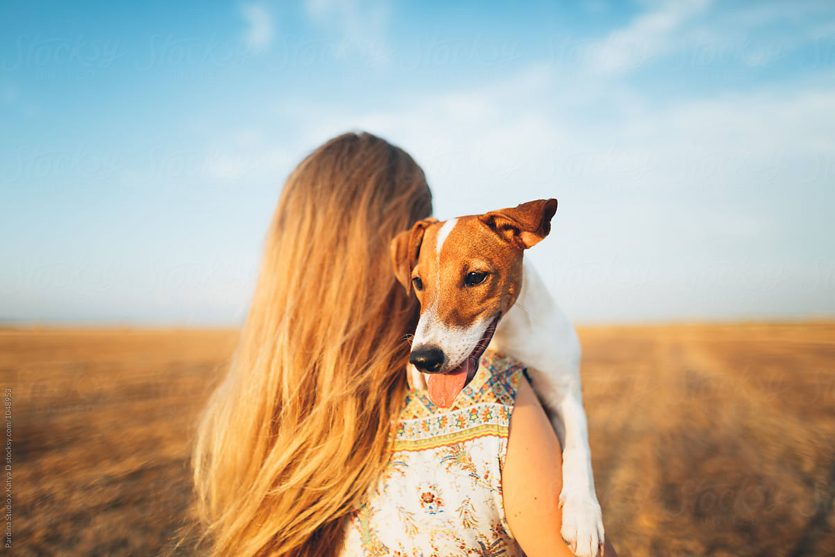 "Child Carrying Dog" by Stocksy Contributor "Javier Pardina" - Stocksy