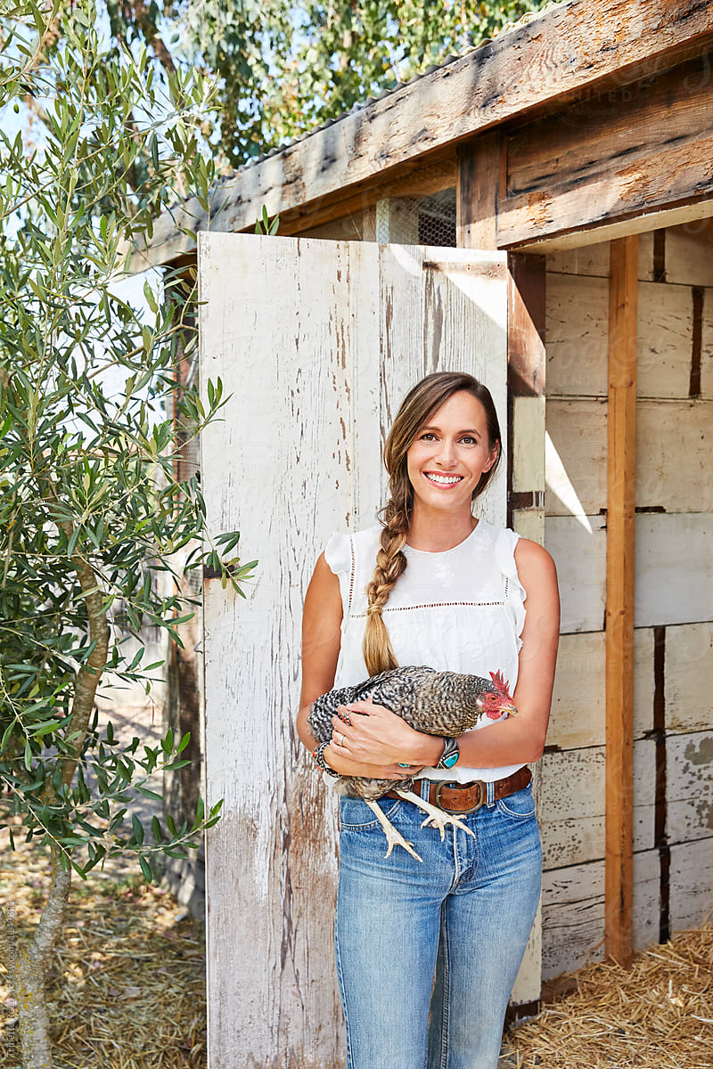 "Beautiful Woman Holding Chicken In Her Backyard Chicken Coop" by ...