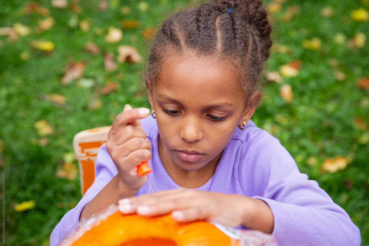 "Young Girl Carving An Orange Pumpkin" by Stocksy Contributor "Anya ...